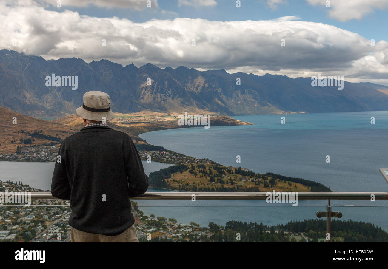 Tourist looking the panorama View of Queenstown and Remarkables ...