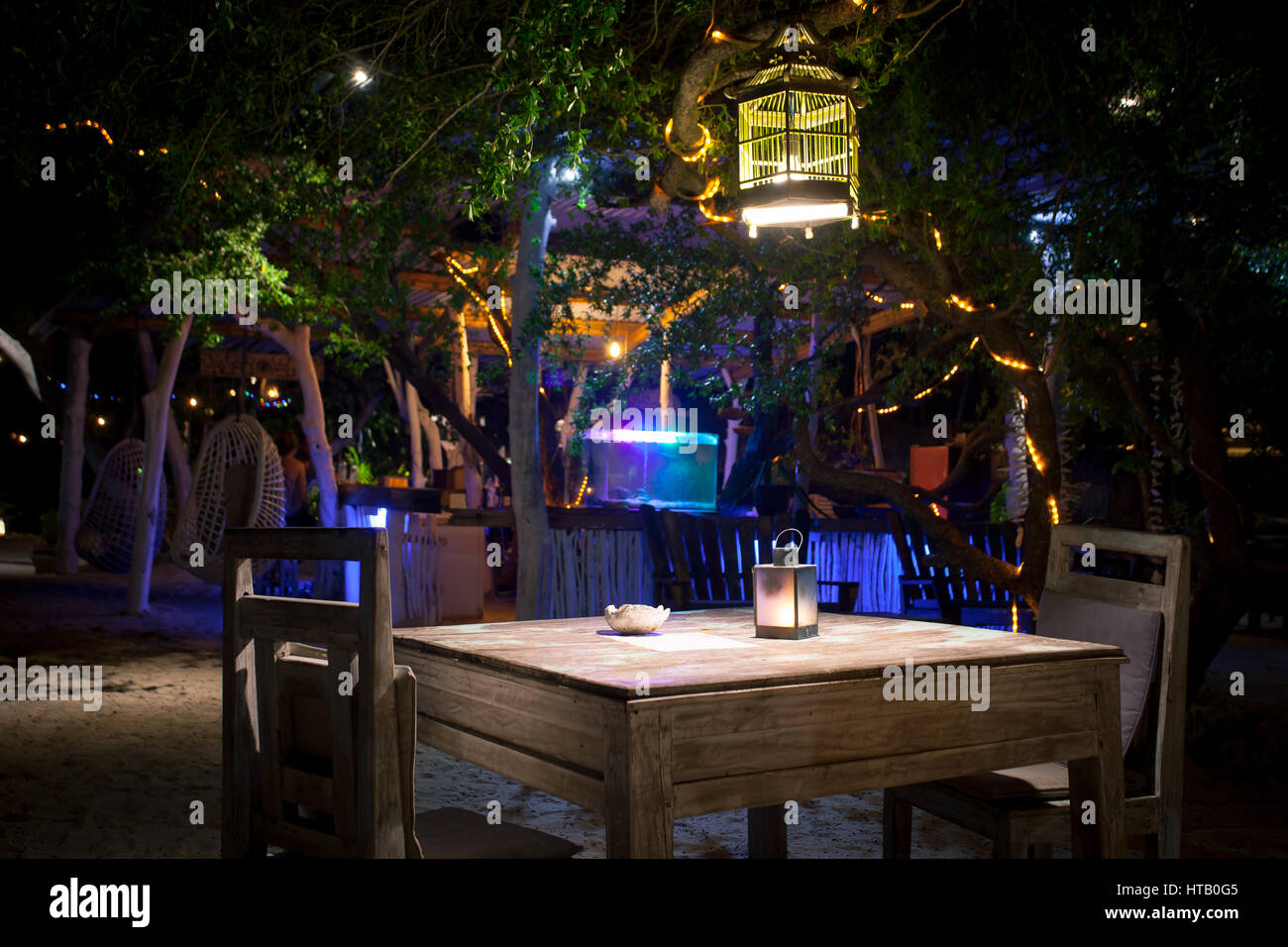 Romantic dinner on the beach in cafes under the open sky under a tree ...