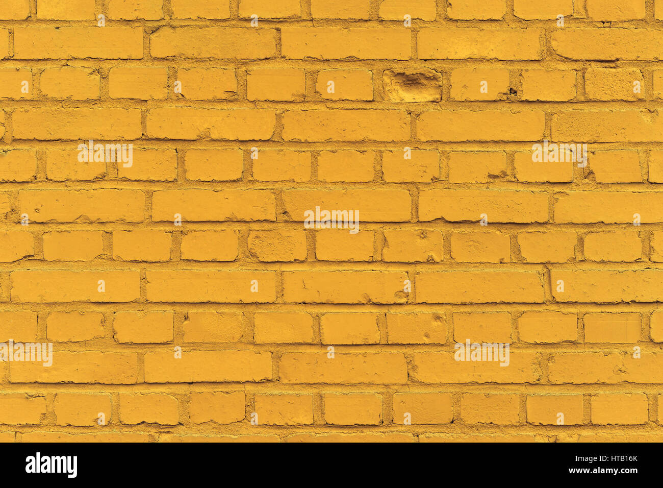 Yellow brick stone wall background Stock Photo - Alamy