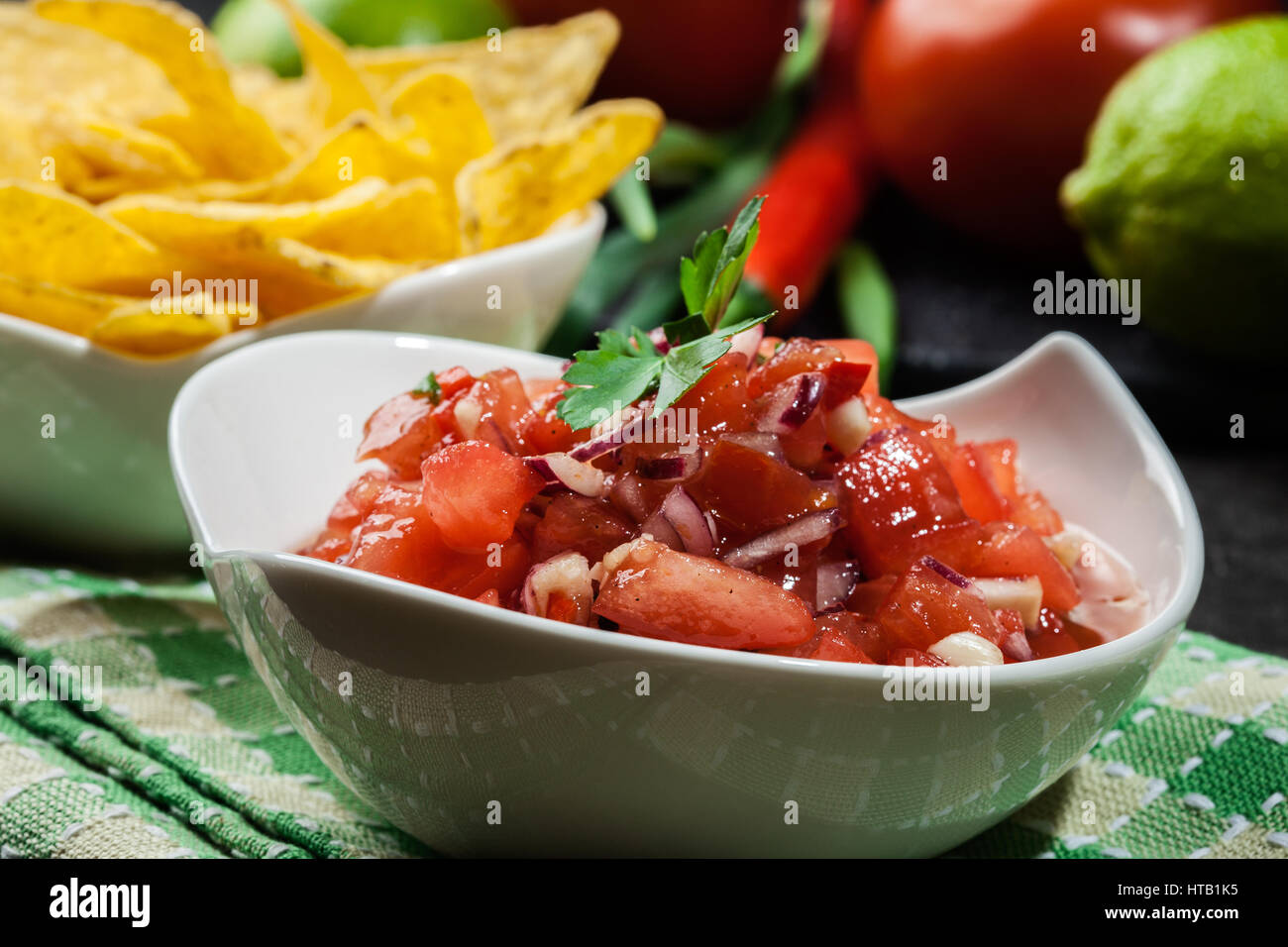 Bowl of fresh salsa with tortilla chips on a table Stock Photo - Alamy
