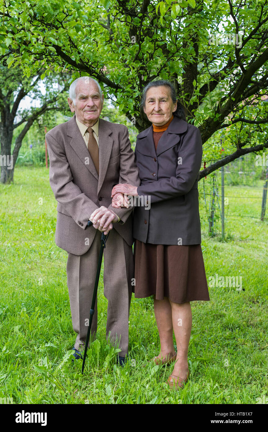 Cute 80 plus year old married couple posing for a portrait in their ...