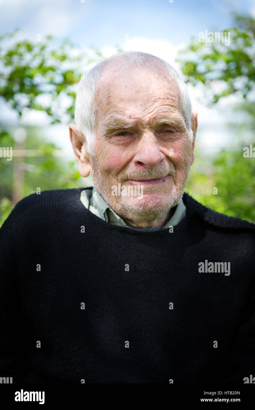 Handsome 80 plus year old senior man posing for a portrait in his ...