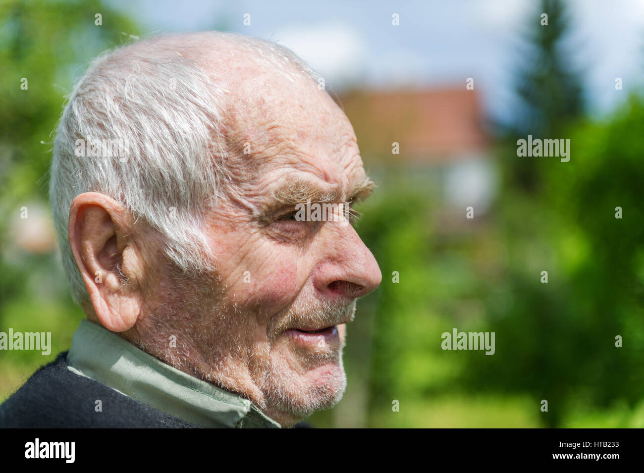 Handsome 80 plus year old senior man posing for a portrait in his ...