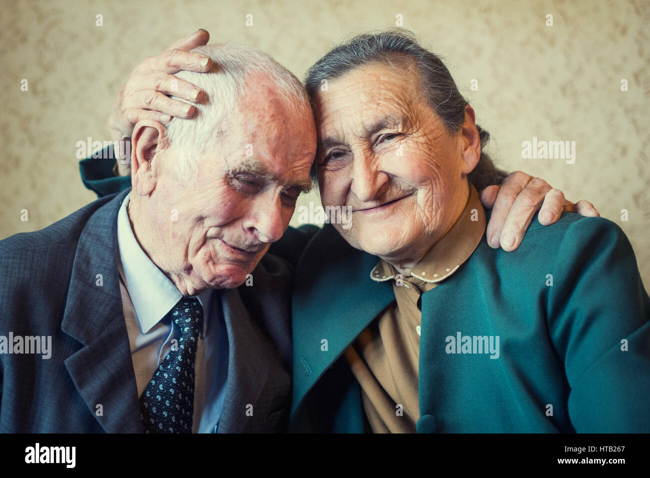 Cute 80 plus year old married couple posing for a portrait in their ...