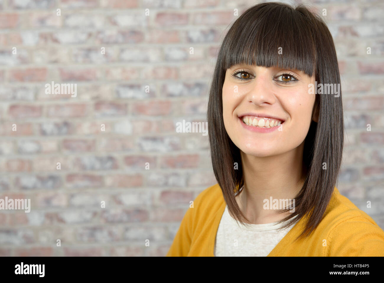 Fashionable pretty brunette wearing bright yellow clothes Stock Photo ...