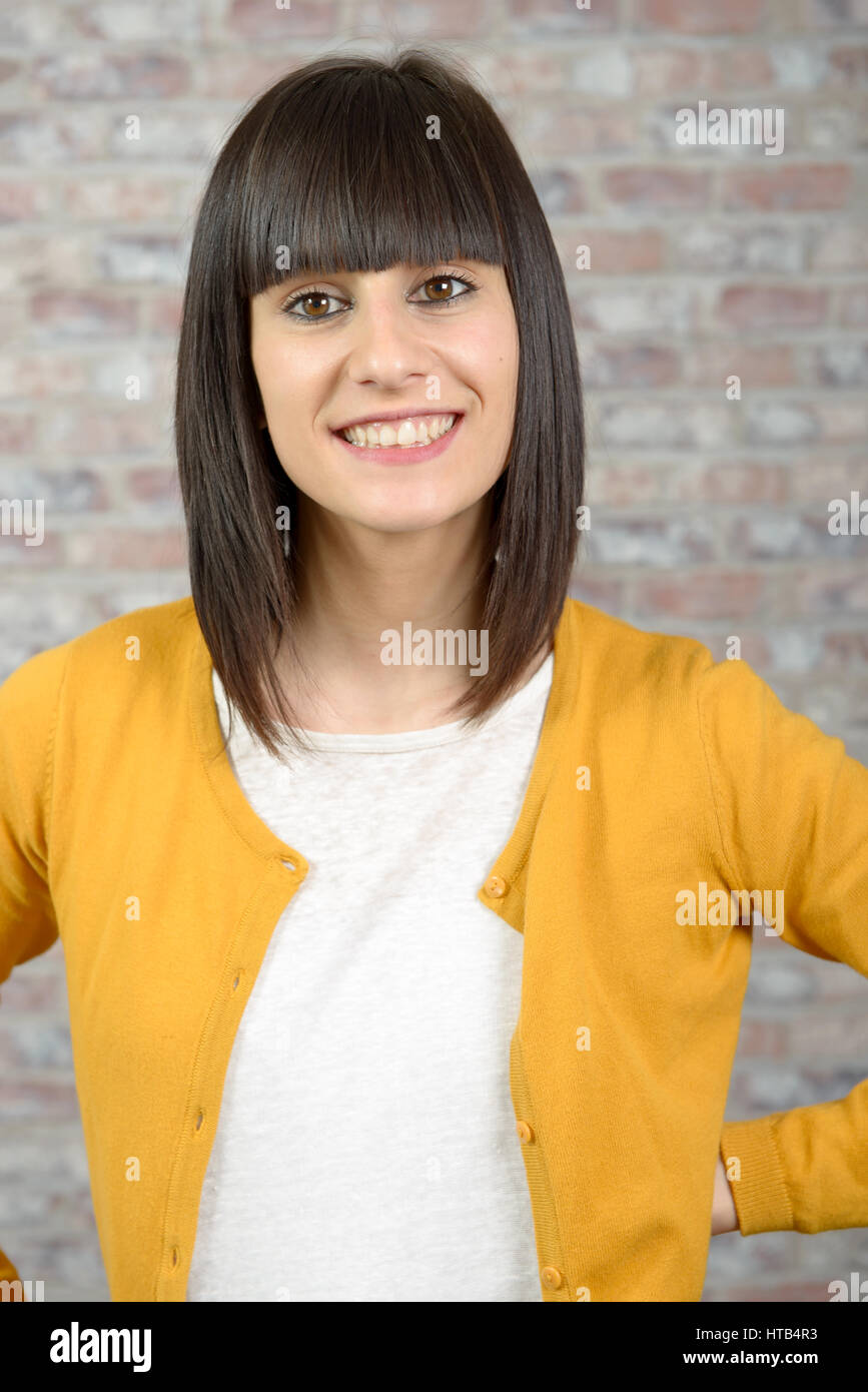Fashionable pretty brunette wearing bright yellow clothes Stock Photo ...