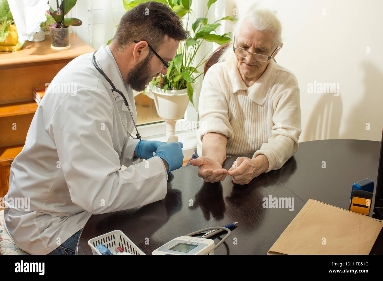 A private doctor's office. Doctor examining an old woman's hand Stock ...