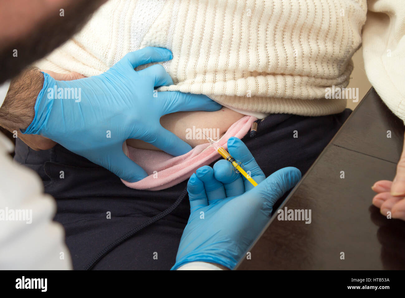 Female doctor syringe patient belly hi-res stock photography and images ...