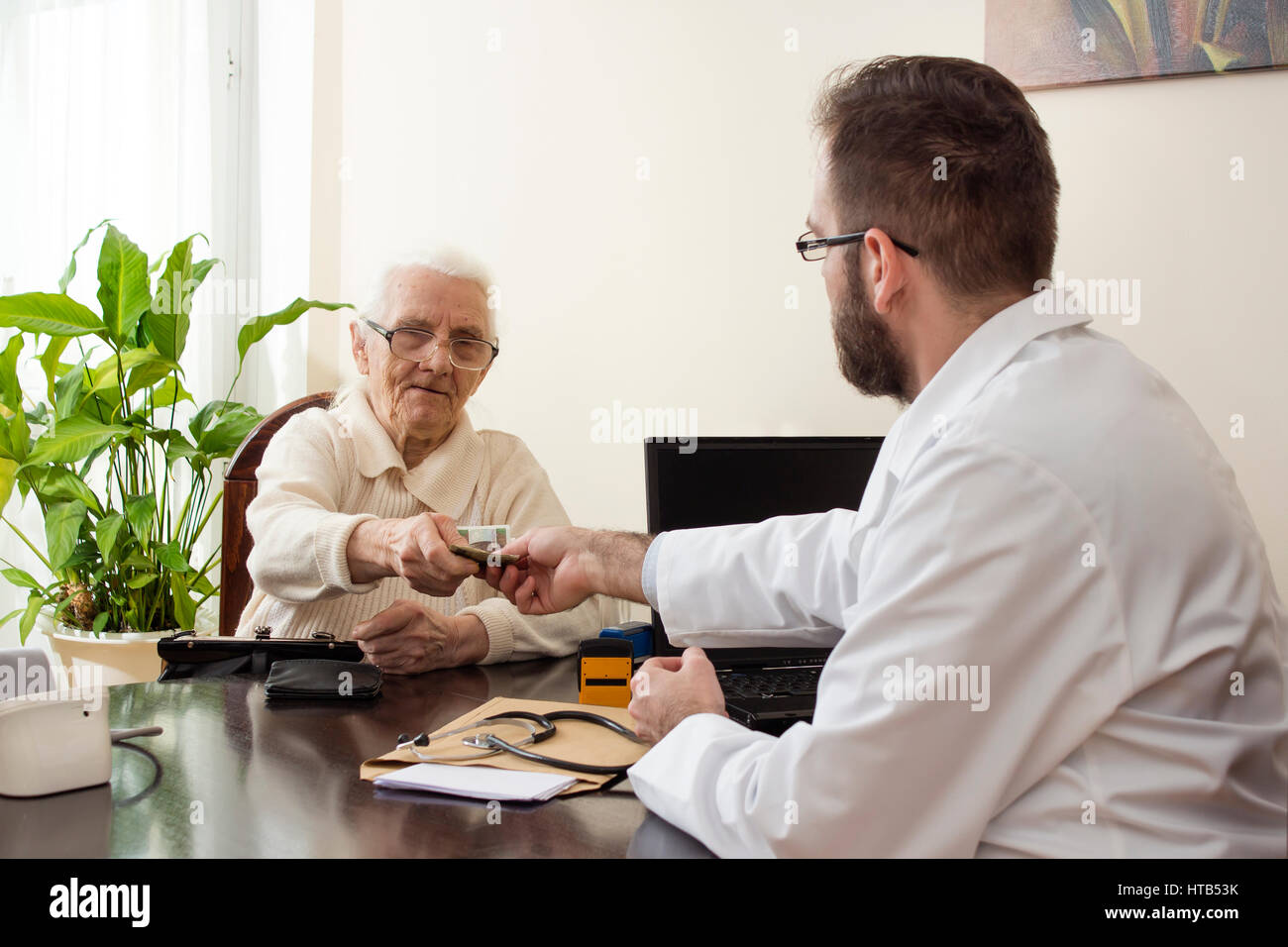 Grandma pays the doctor for a visit to a private doctor's office. The ...
