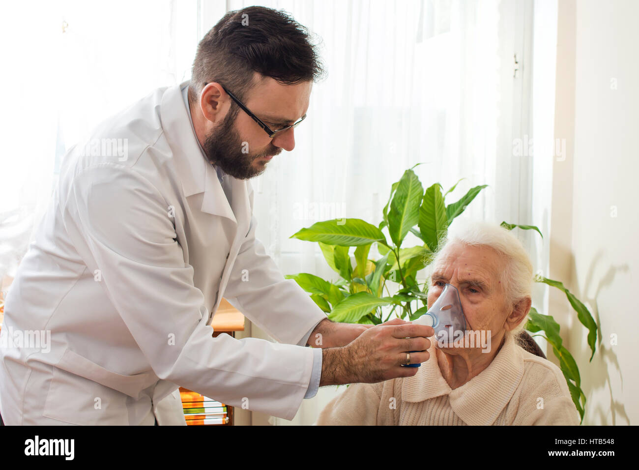 The doctor's office conducted inhalation. The doctor holds inhaler the ...