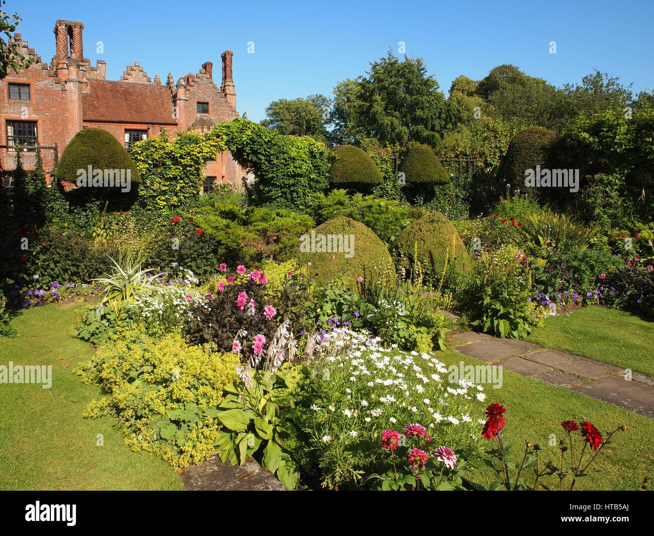 Chenies Manor overlooking the colourful sunken garden in July, in full ...