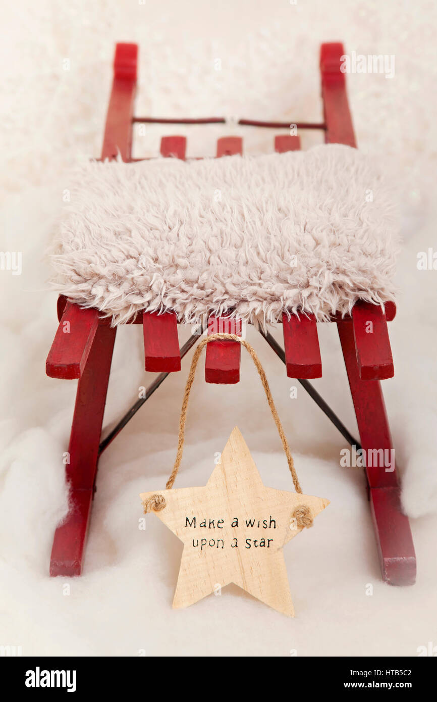 Christmas Red Sledge, with wooden star Stock Photo - Alamy