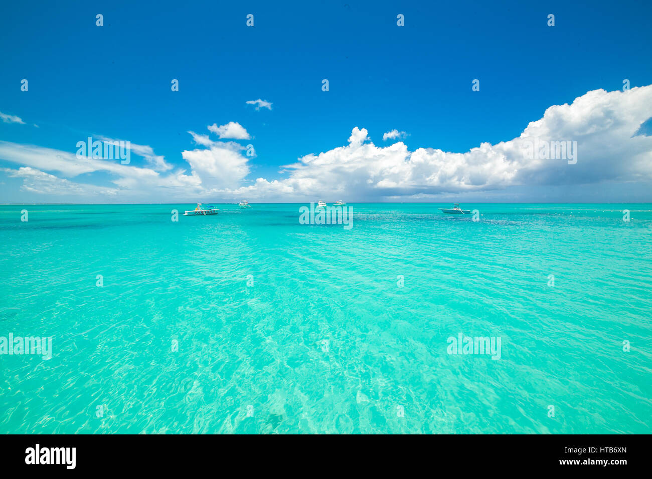 Landscape of beach with crystal clear blue water, clouds, and blue ...