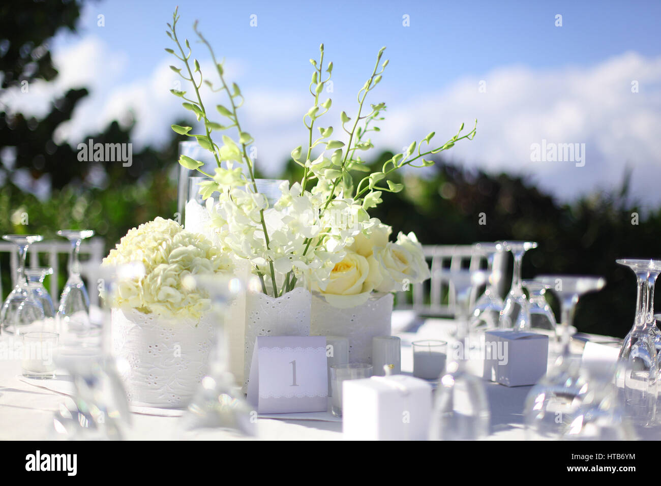 Flowers on white wedding tables Stock Photo - Alamy