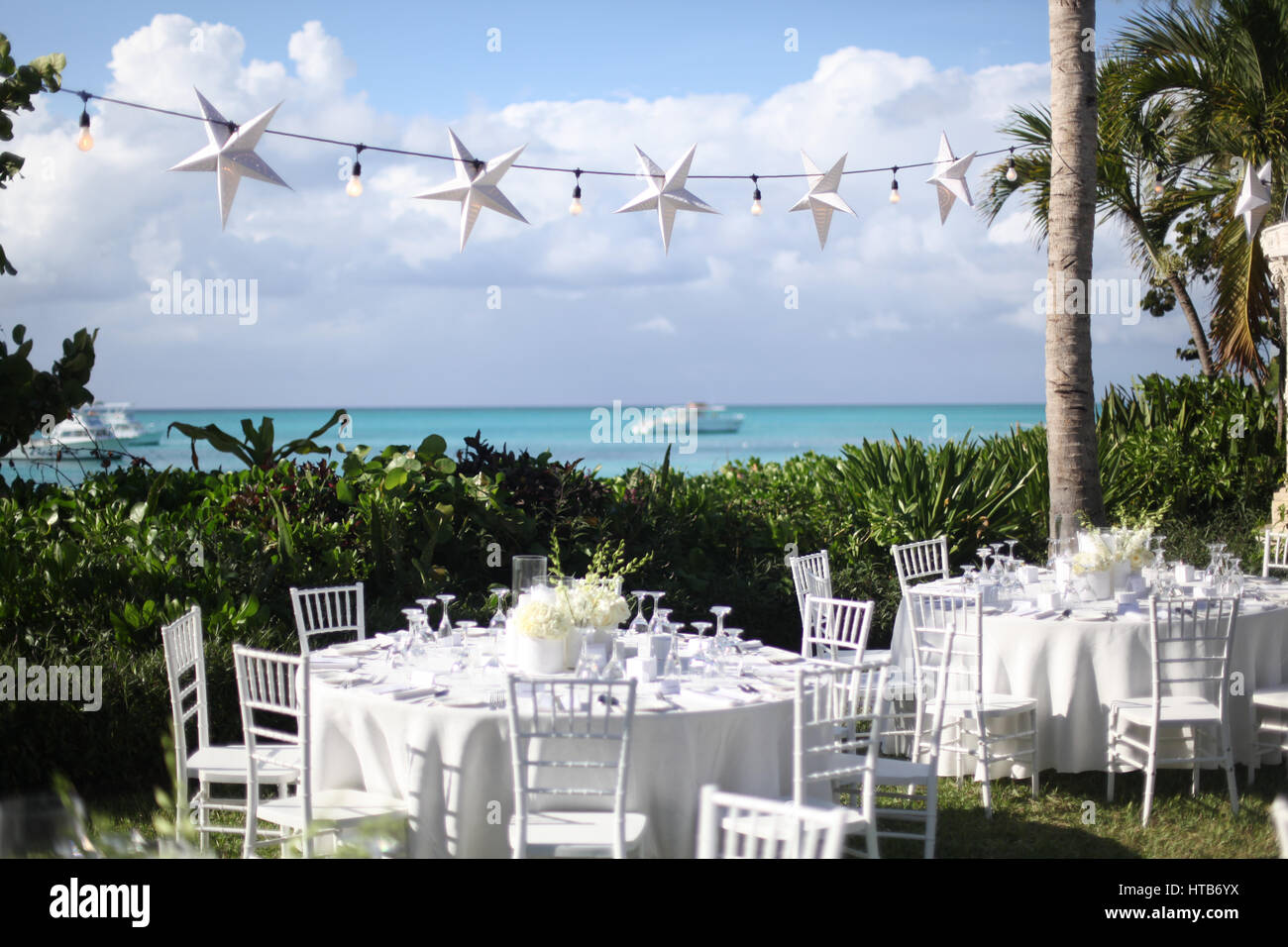 Wedding tables and decorations with ocean side view Stock Photo - Alamy