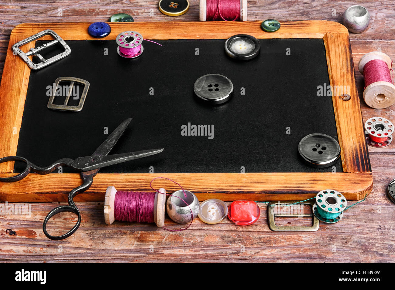buttons and thread on the chalk board for drawing Stock Photo - Alamy
