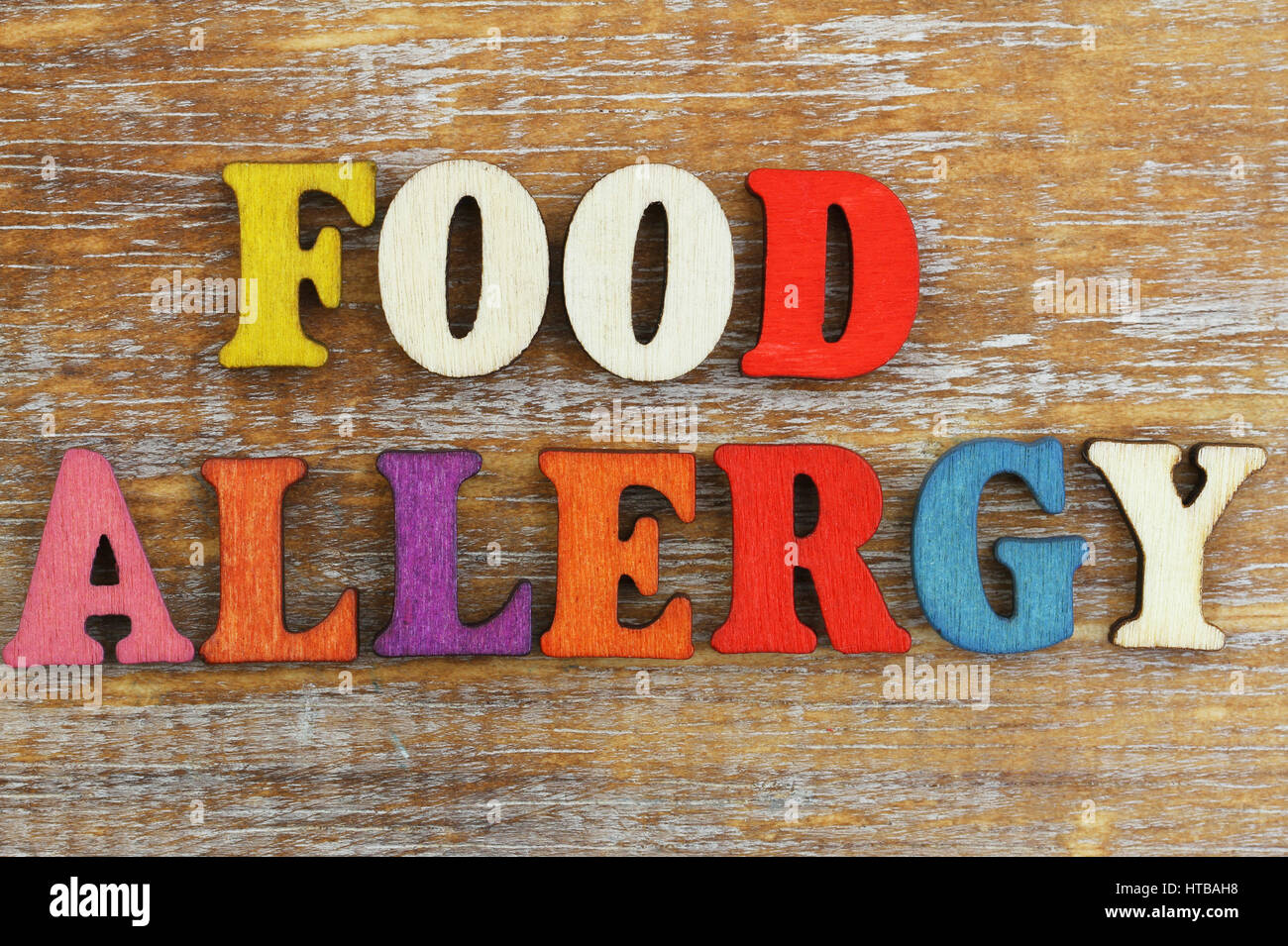 Food allergy written with colorful letters on wooden surface Stock ...