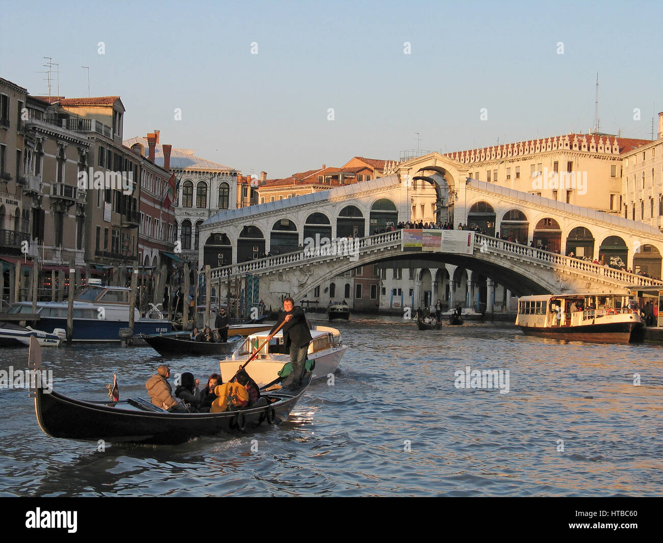 Tourists enjoying a scenic gondola ride on the Grand Canal in Venice ...