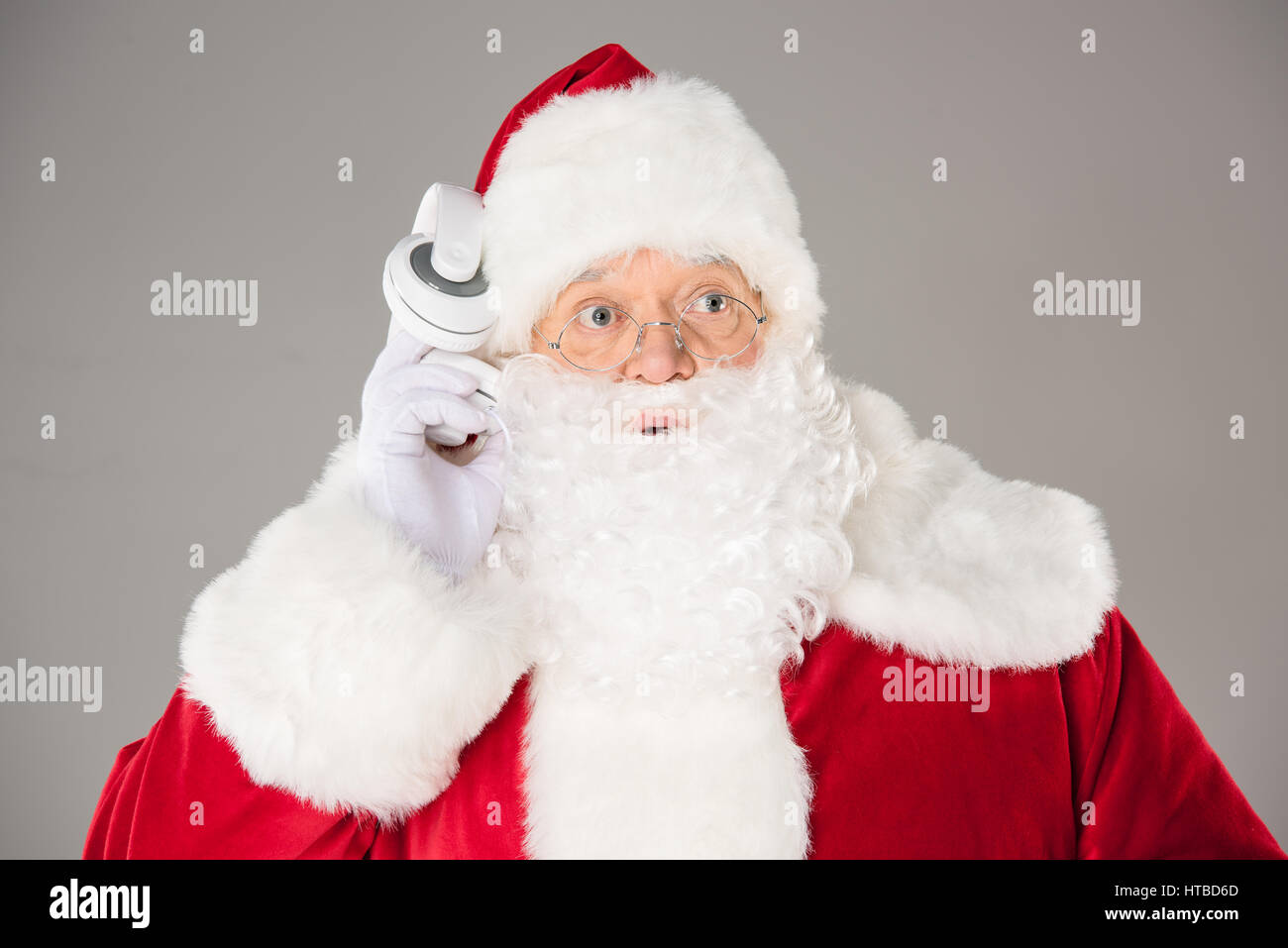 Happy Santa Claus listening music with headphones and posing Stock ...