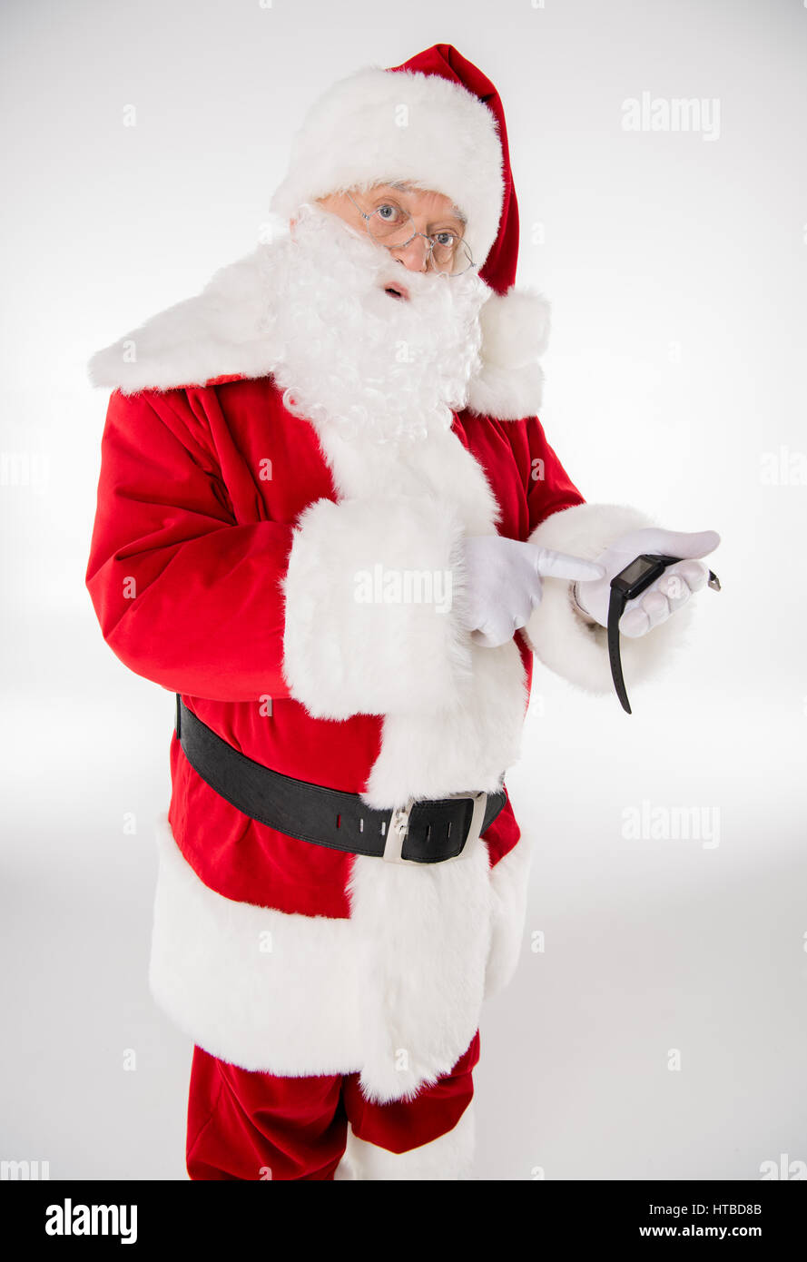 Happy Santa Claus pointing on smartwatch and looking at camera Stock ...