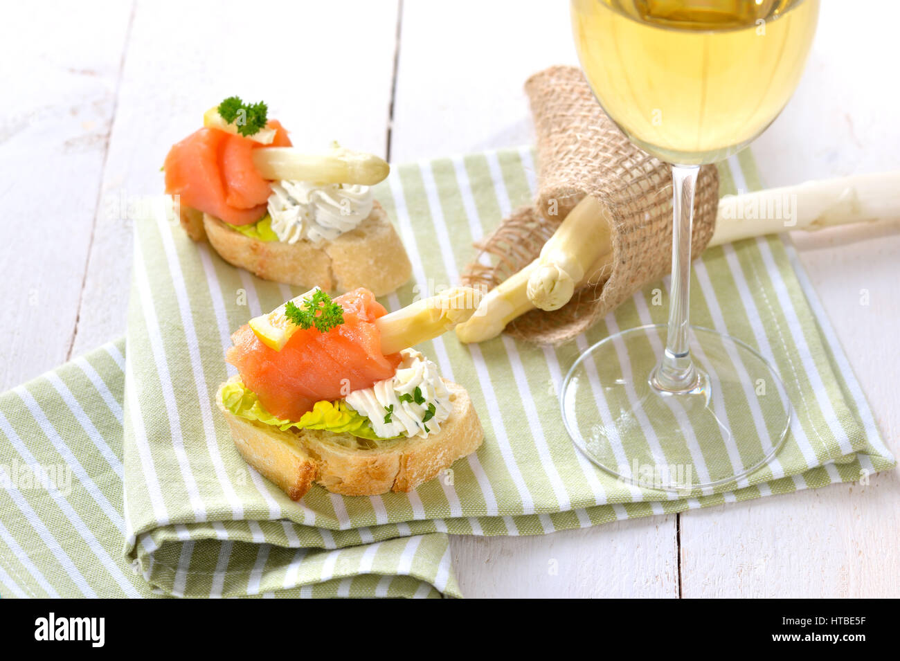 Delicious canapes with white asparagus, cream cheese with herbs, smoked ...
