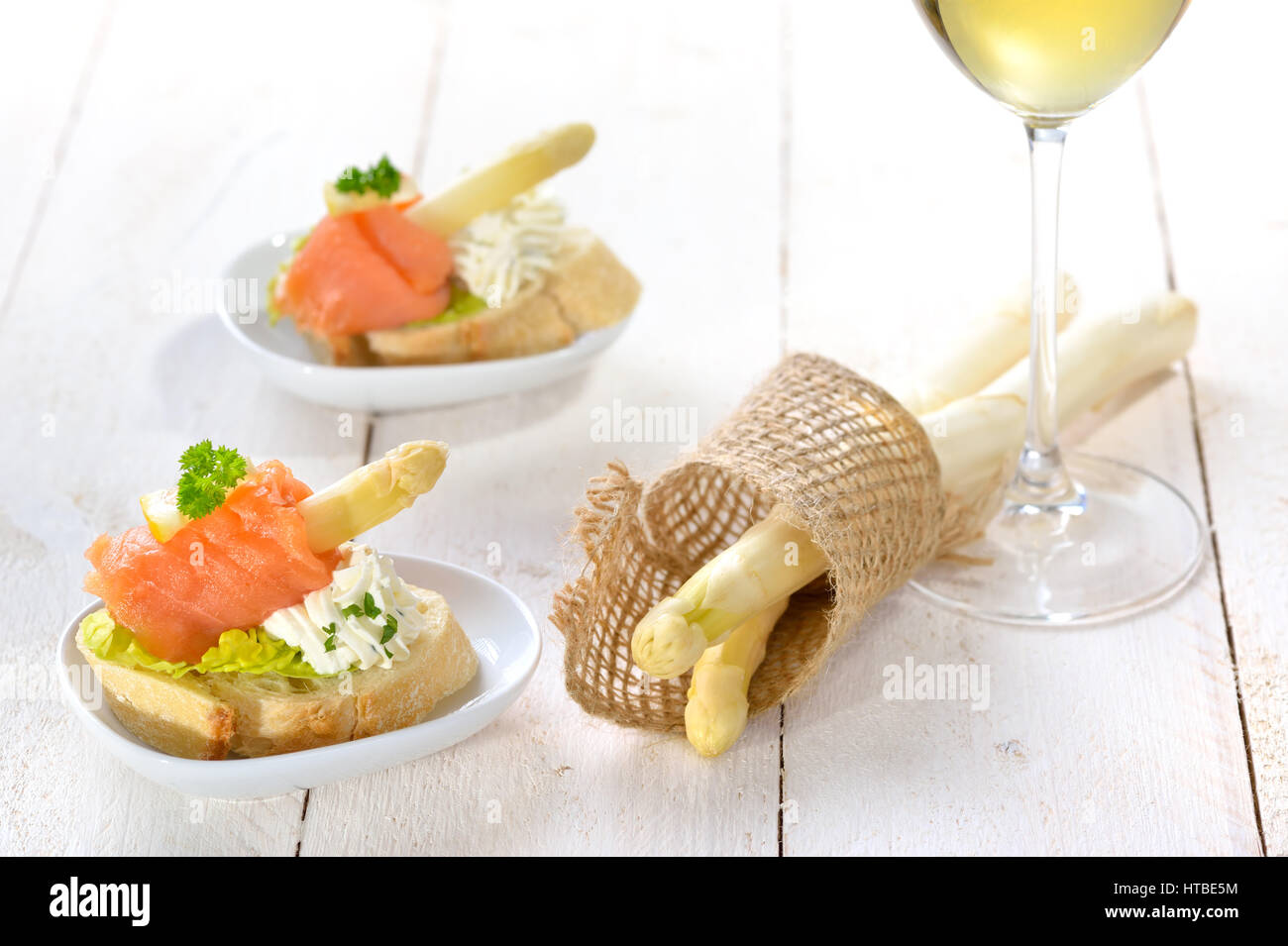 Delicious canapes with white asparagus, cream cheese with herbs, smoked ...