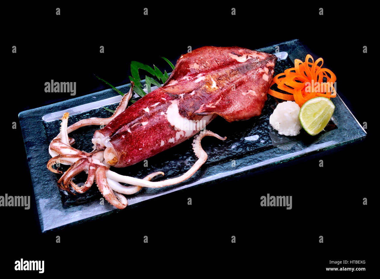 Japanese grilled squid full body in glass plate photo in studio ...