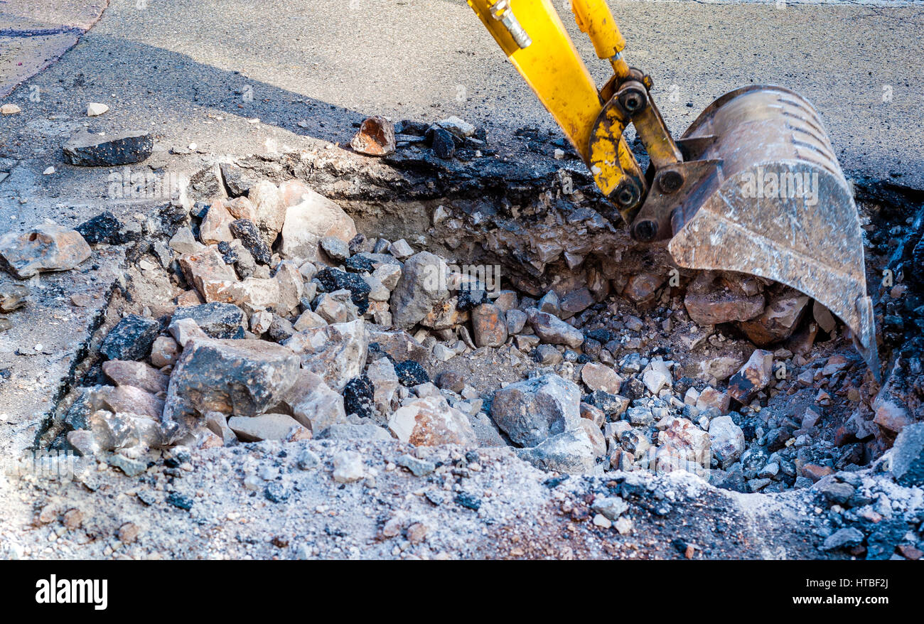 Working Excavator Tractor Digging street city Stock Photo - Alamy
