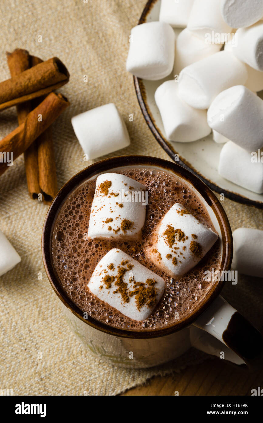 hot cocoa with marshmallow on rustic table Stock Photo - Alamy