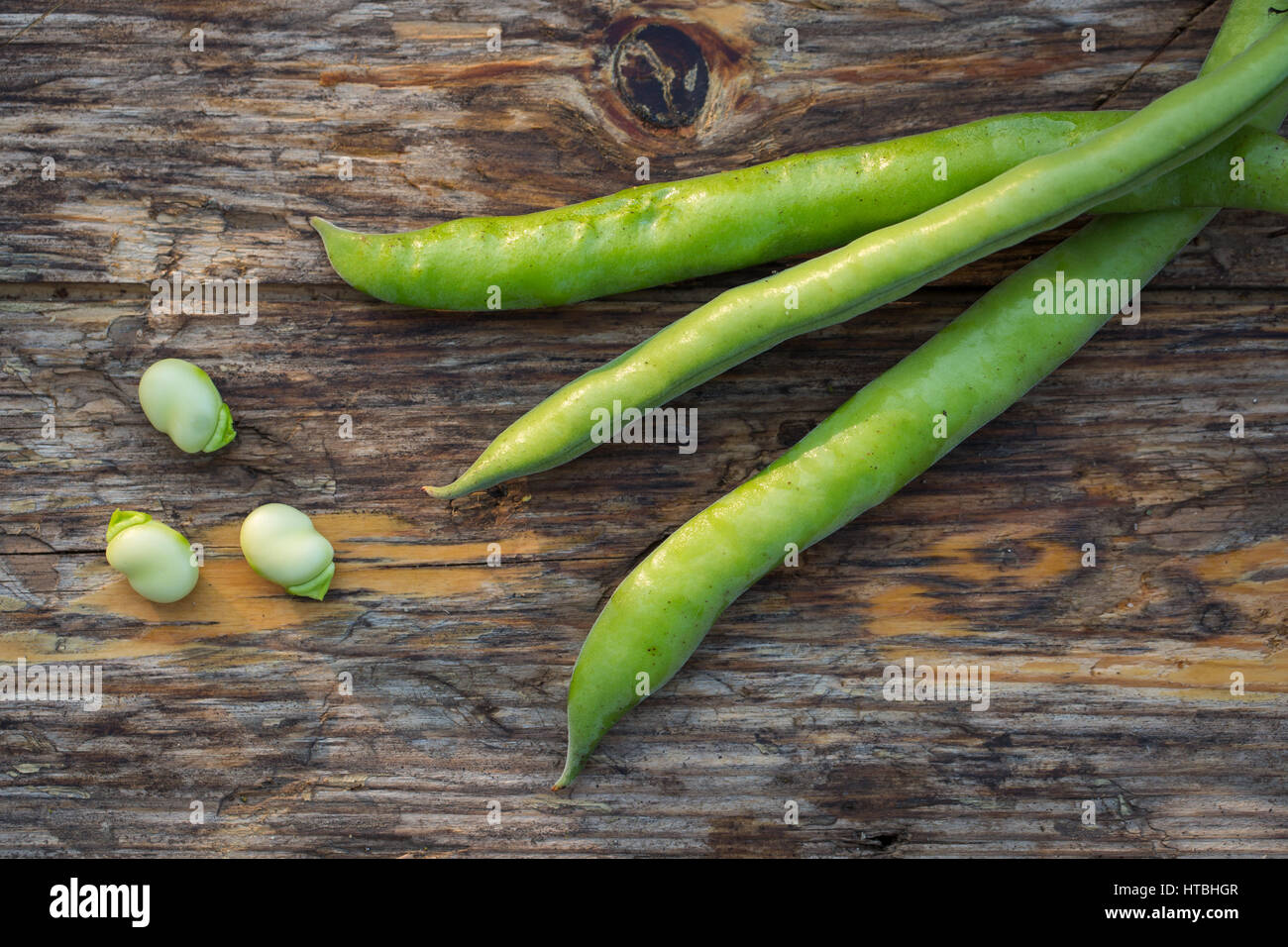 Fresh raw fava beans on a rustic wooden background Stock Photo - Alamy