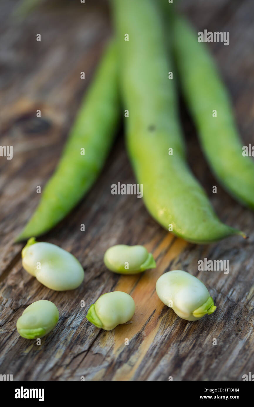 Fresh raw fava beans on a rustic wooden background Stock Photo - Alamy