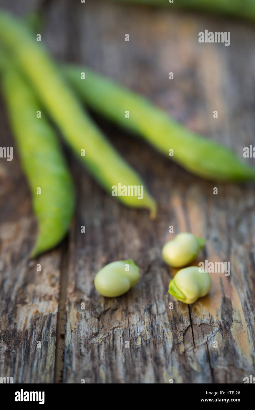Fresh raw fava beans on a rustic wooden background Stock Photo - Alamy