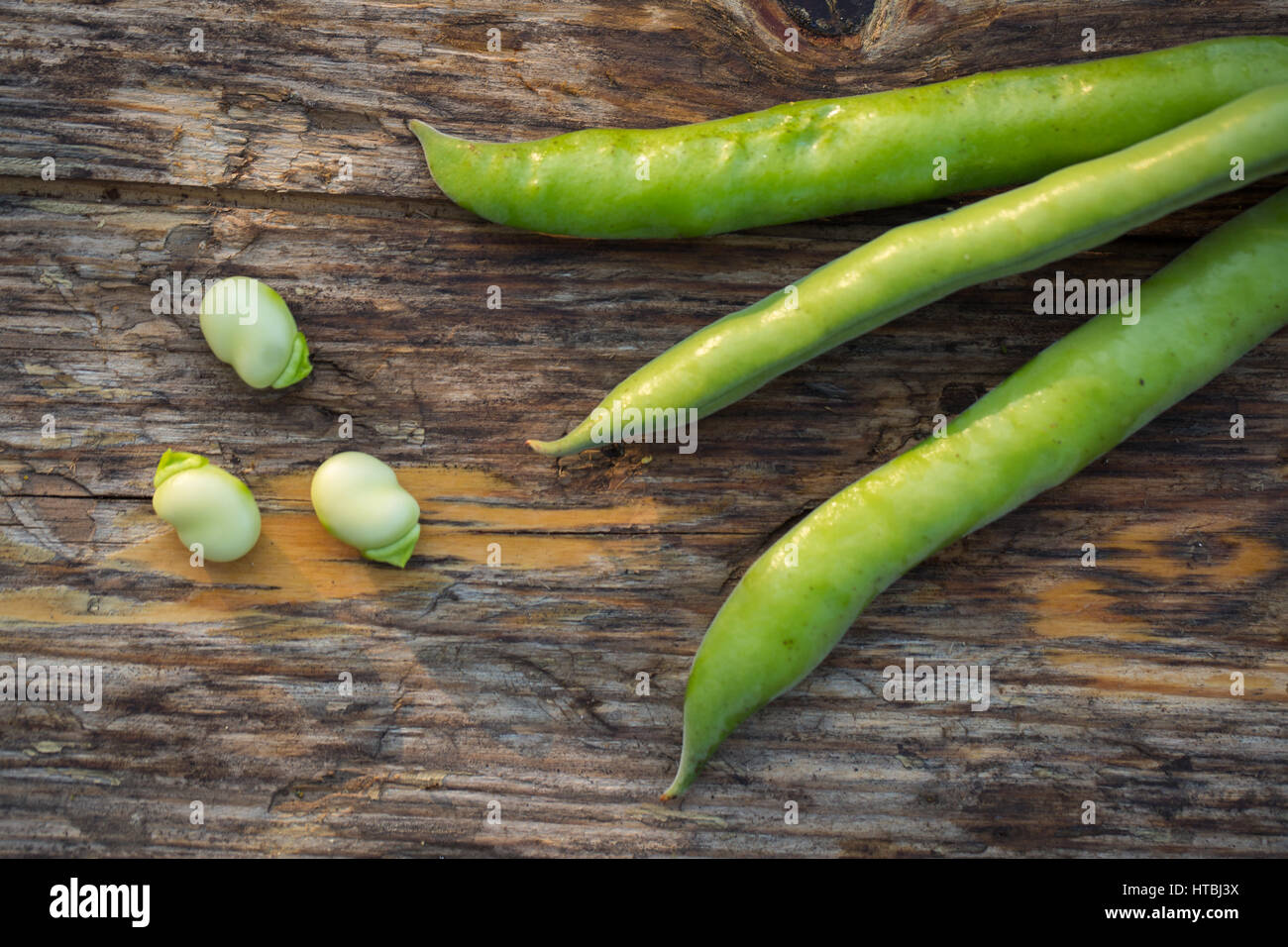 Fresh raw fava beans on a rustic wooden background Stock Photo - Alamy