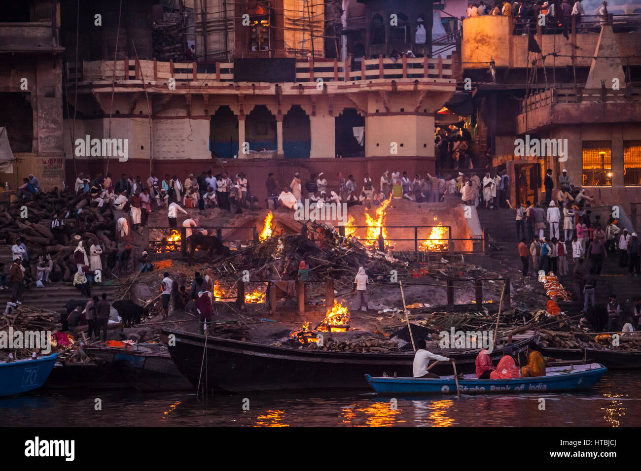 The open funeral pires / cremation fires at Manikarnika Ghat along the ...