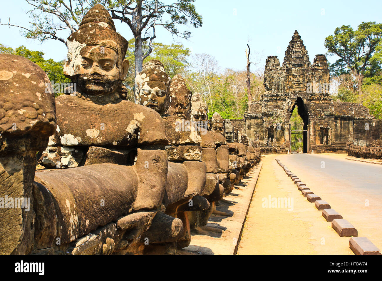 South gate to angkor thom in Cambodia is lined with warriors and demons ...