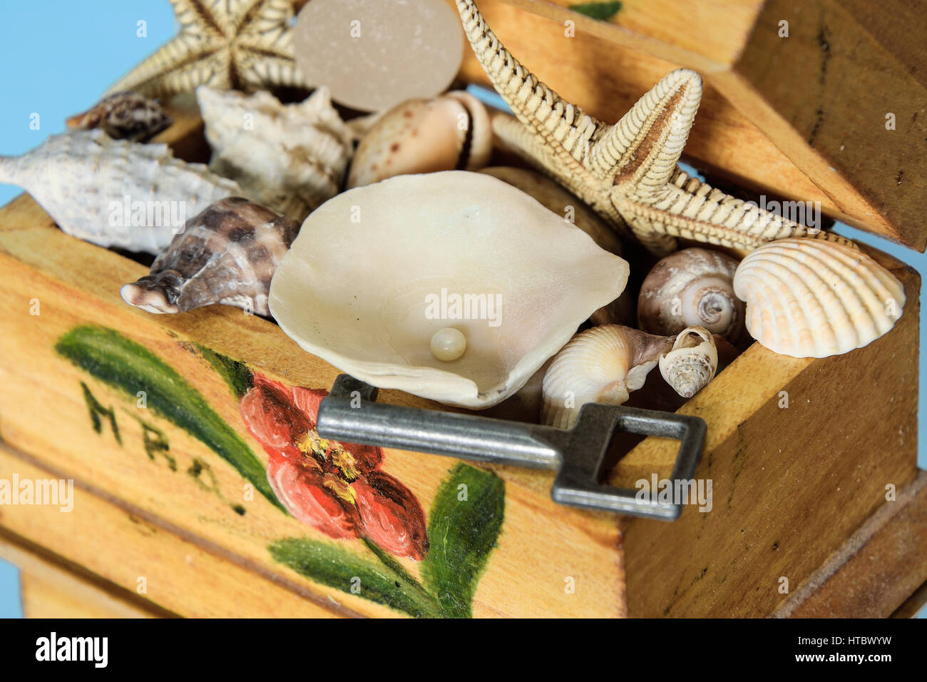 Wooden box with pearl shell, shells, and a key for the treasure Stock ...
