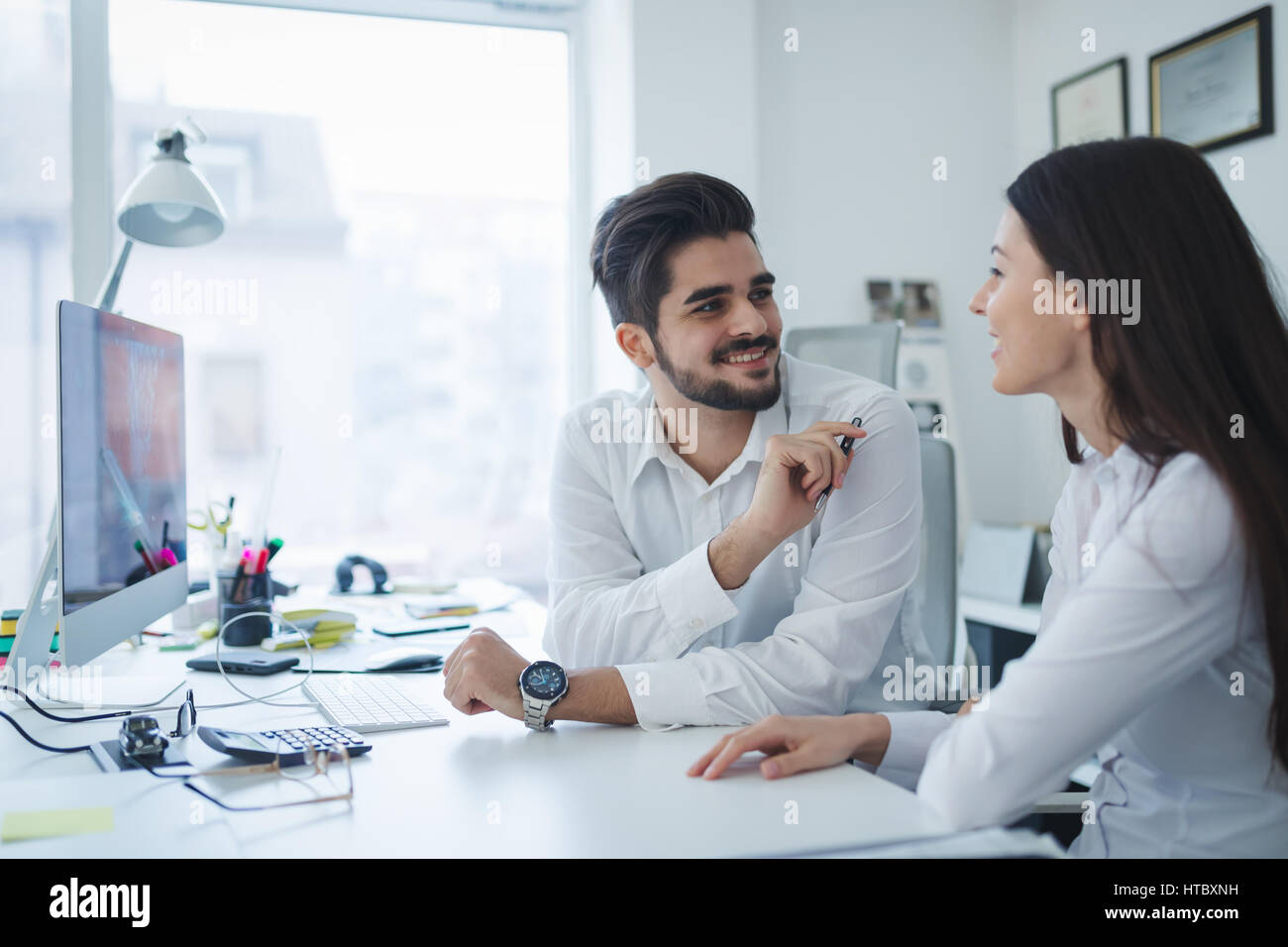 Happy collaborating business colleagues discussing future plans Stock ...