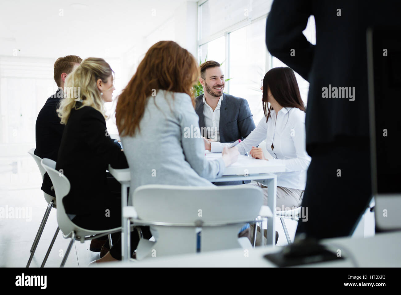 Group of business people collaborating on project in office Stock Photo ...