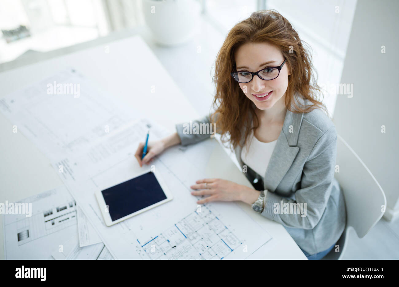 Beautiful female architect working on plan in company office Stock ...