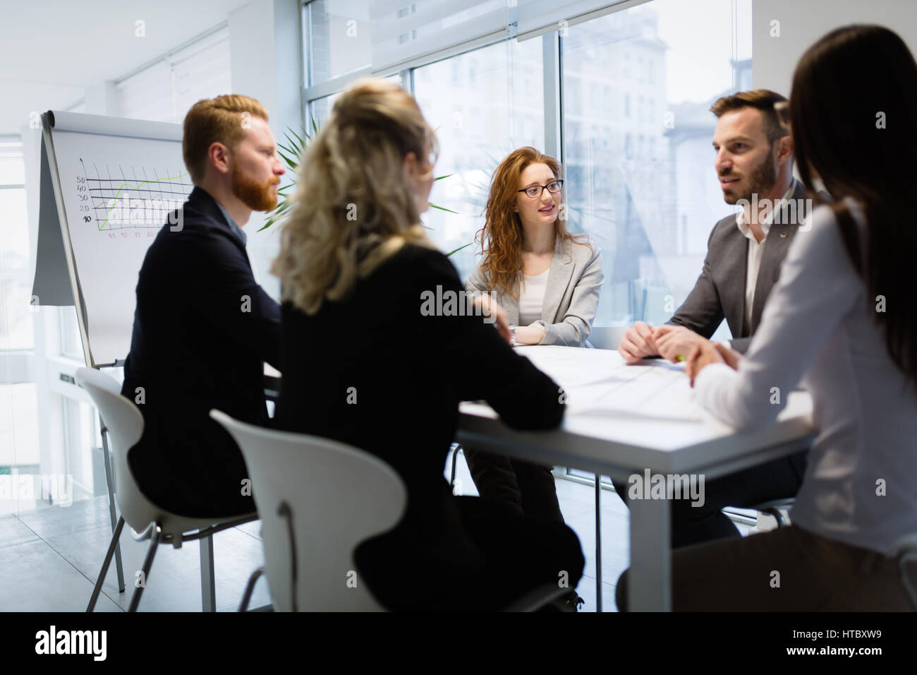Colleagues attending seminars and business meetings in company office ...