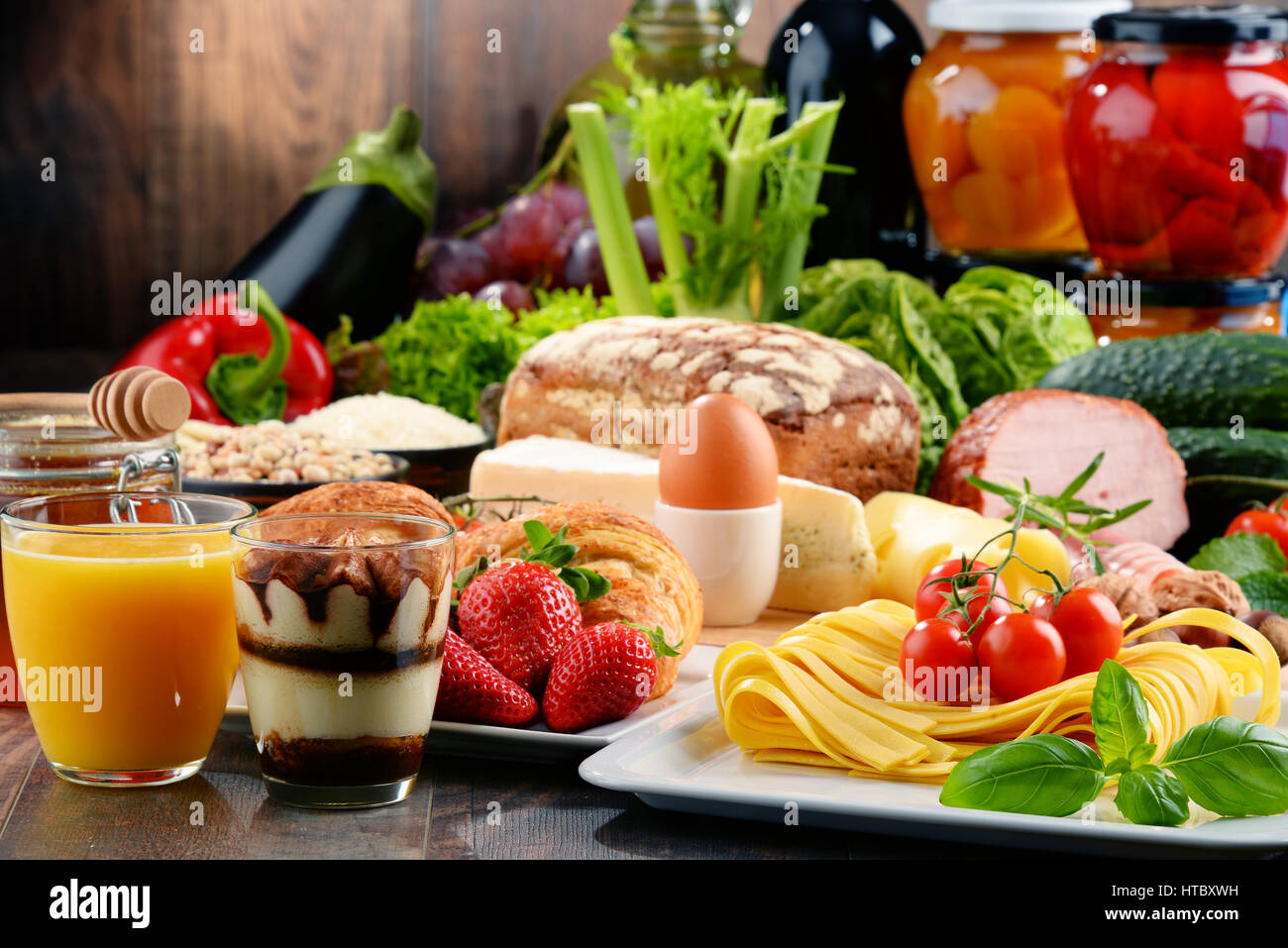 Composition with variety of organic food products on kitchen table ...