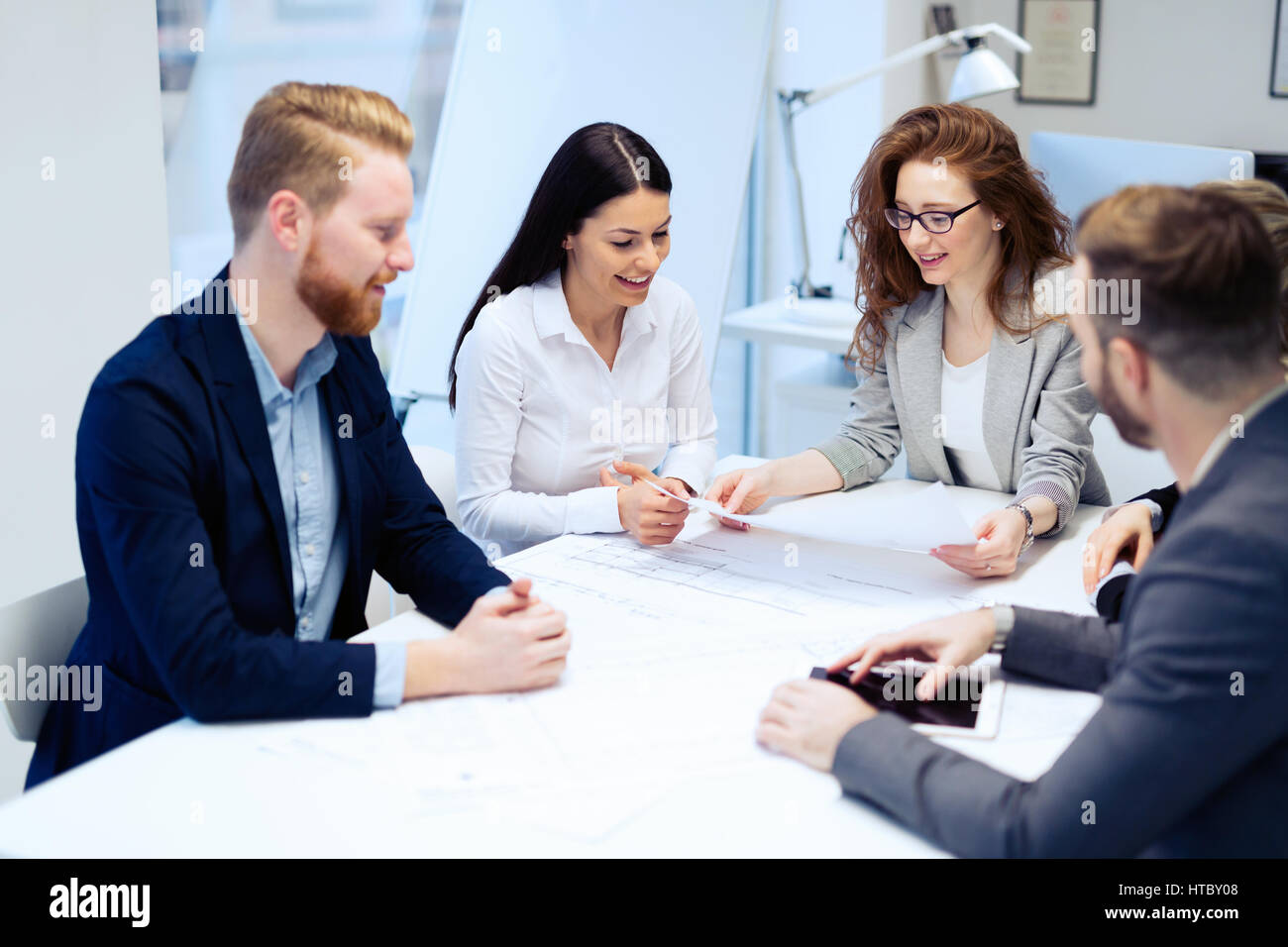 Group of business people collaborating on project in office Stock Photo ...