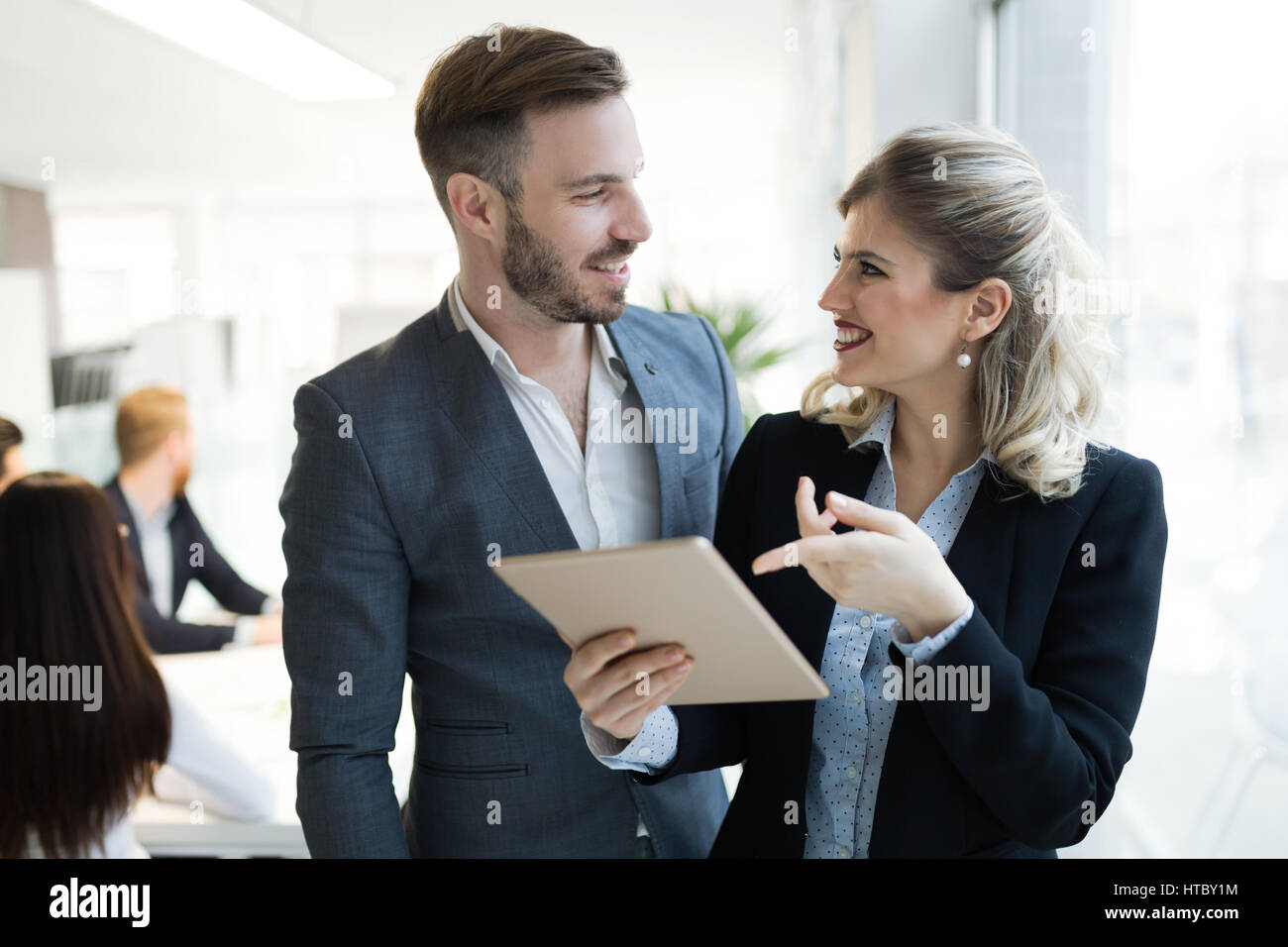 Professional business people cooperating in company office Stock Photo ...