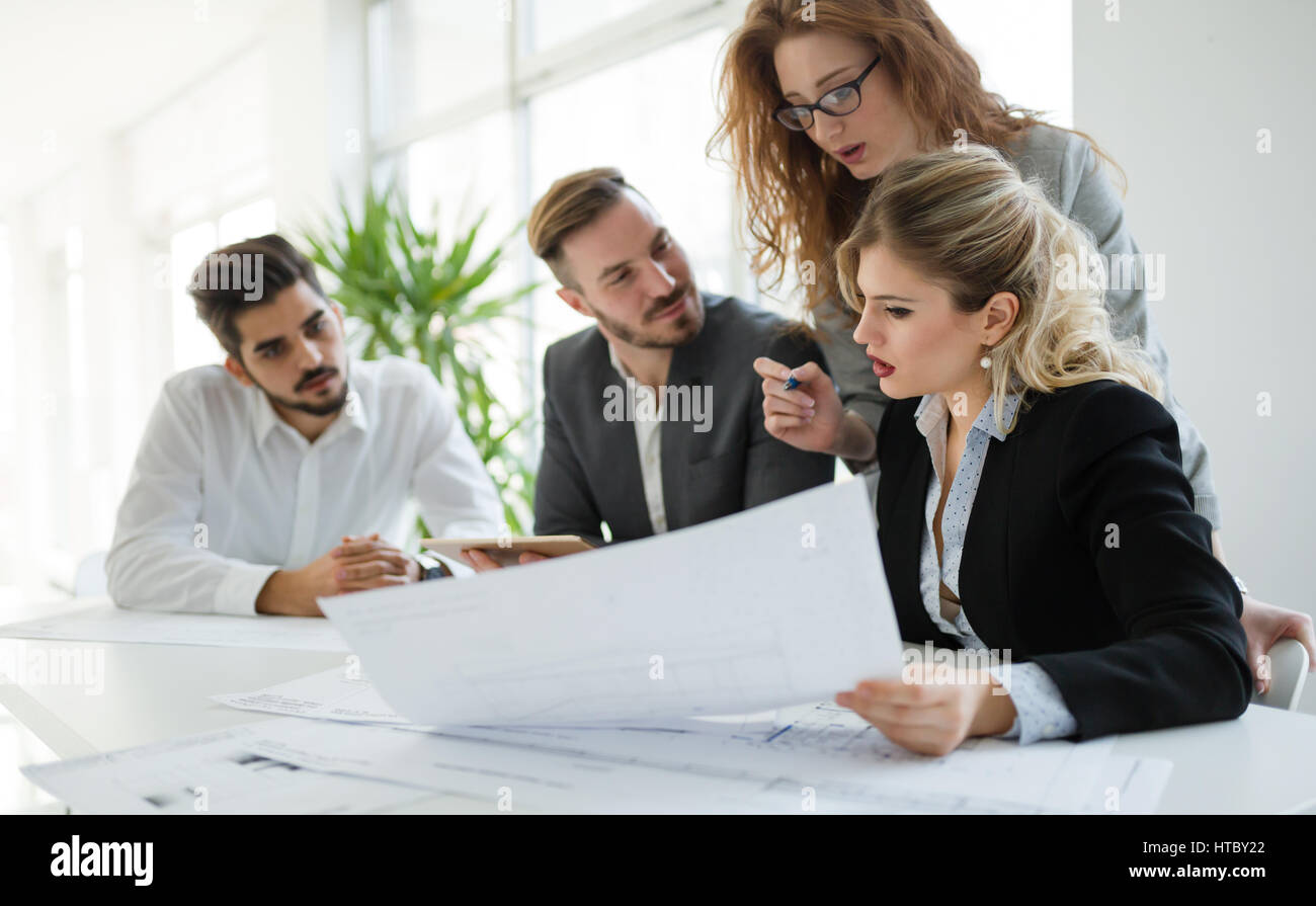 Happy business colleagues working in company office Stock Photo - Alamy