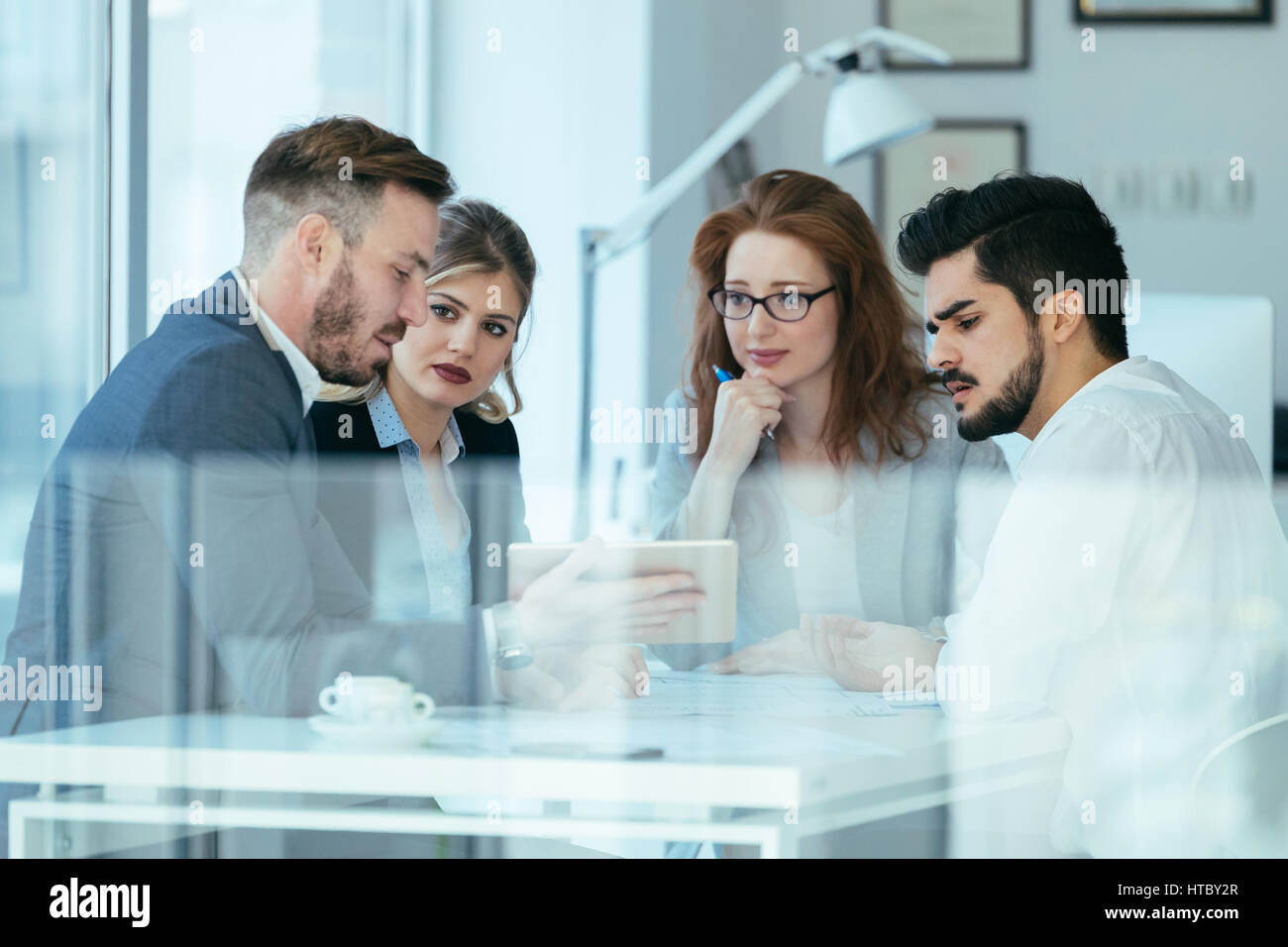 Group of business people collaborating on project in office Stock Photo ...