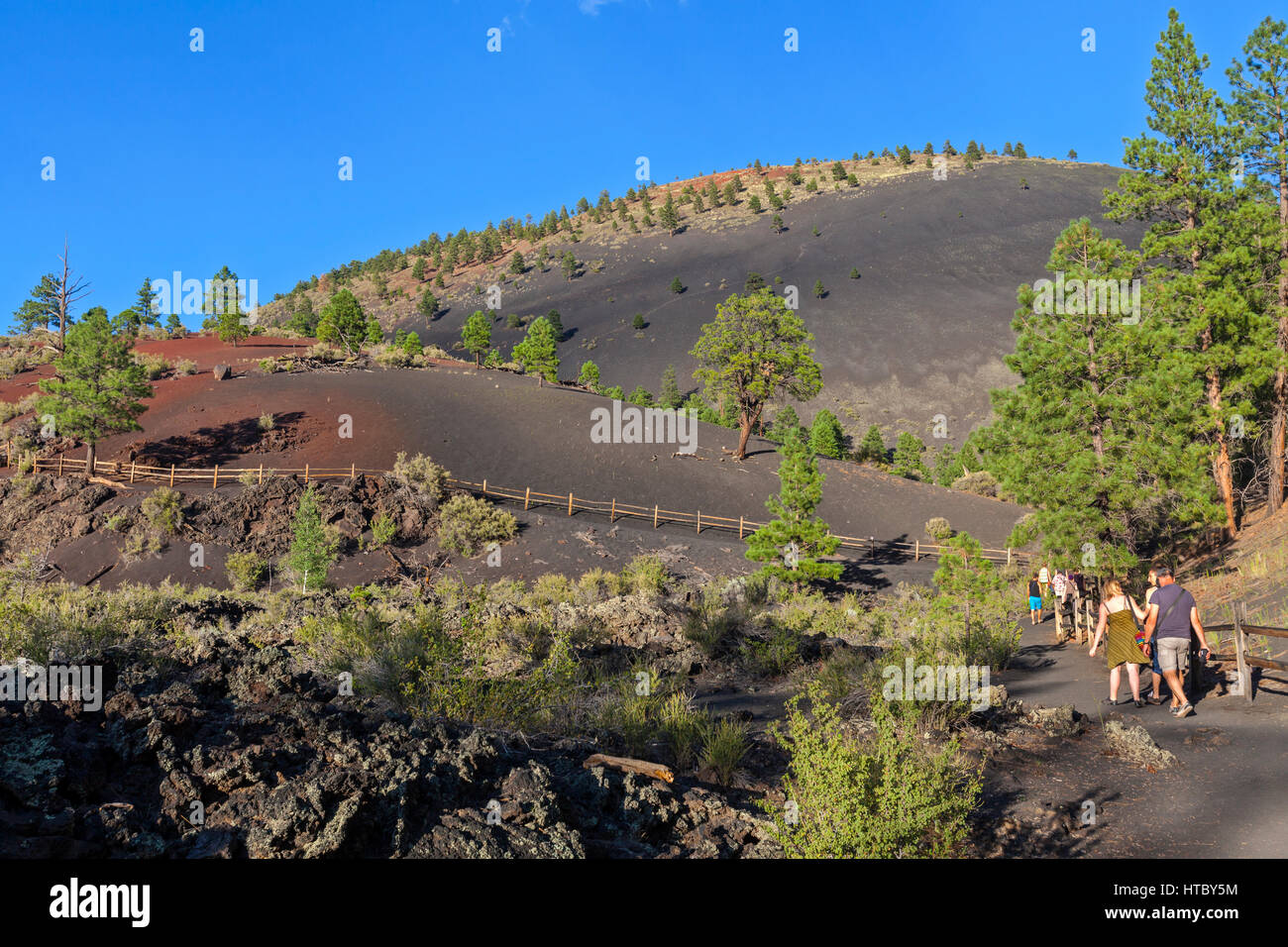 Tourists exploring Sunset Crater Volcano National Monument, Arizona ...
