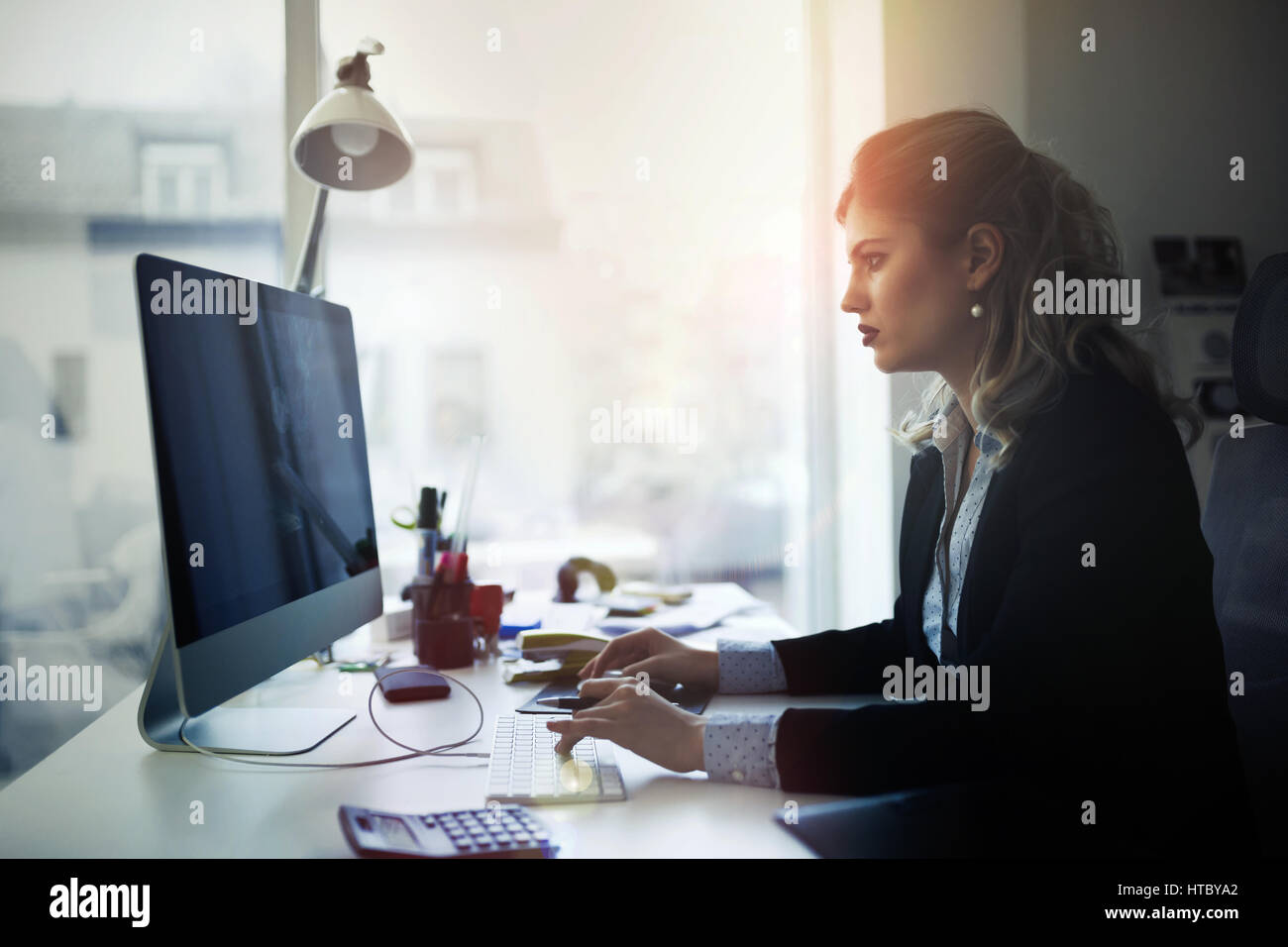 Female office worker late hi-res stock photography and images - Alamy