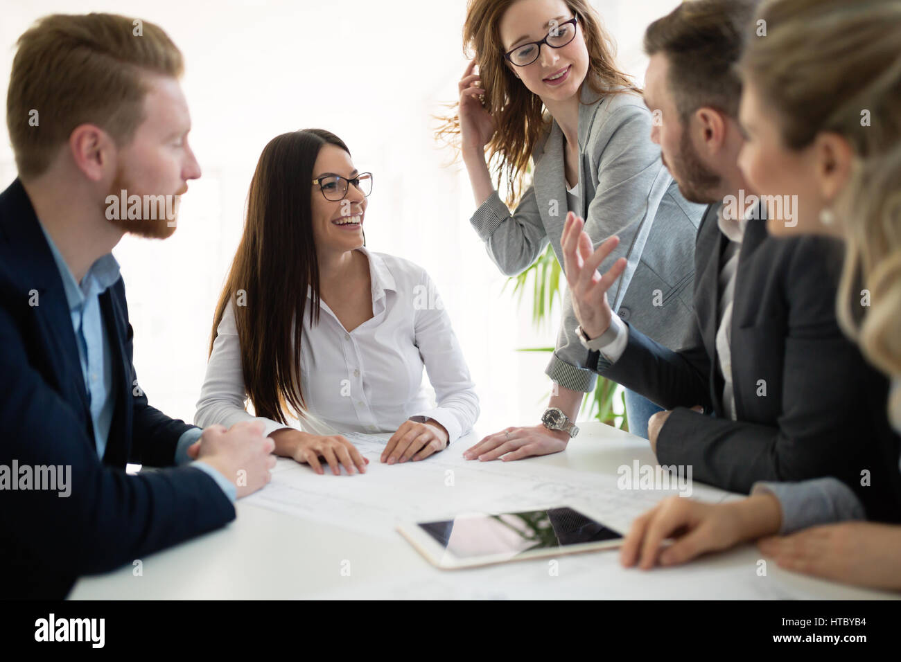 Group of business people collaborating on project in office Stock Photo ...