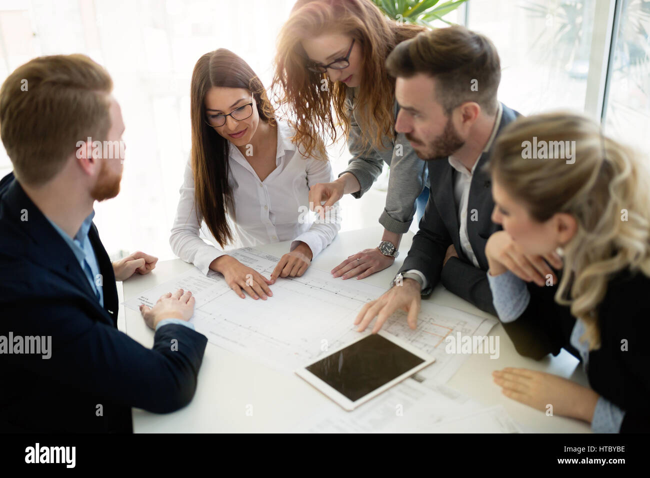 Business people and architects collaborating on business project Stock ...