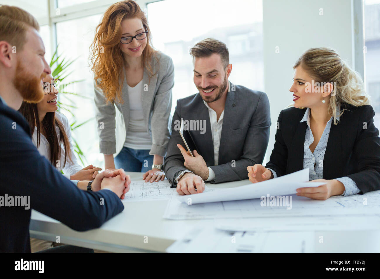 Group of business people collaborating on project in office Stock Photo ...